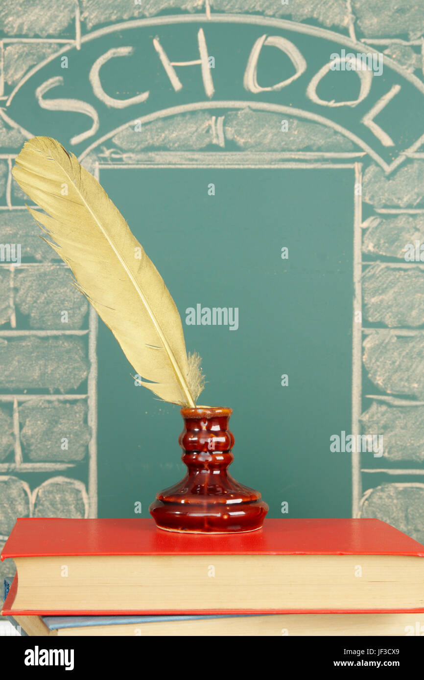 Quill pen in inkwell before entry school pictured with chalk on ...