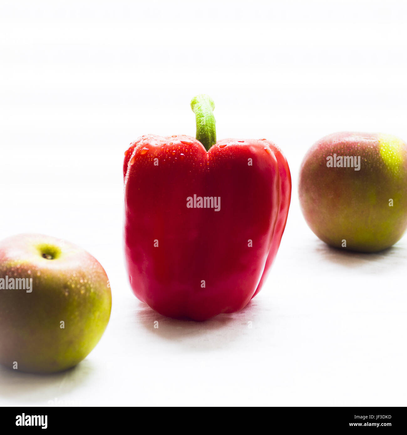 Red pepper with two apples Stock Photo - Alamy