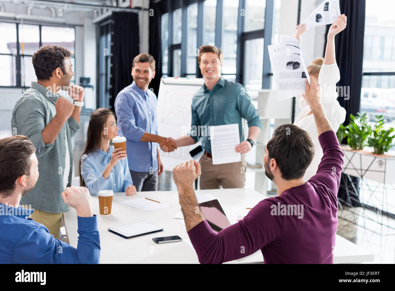 business team celebrating success together on workplace in office ...