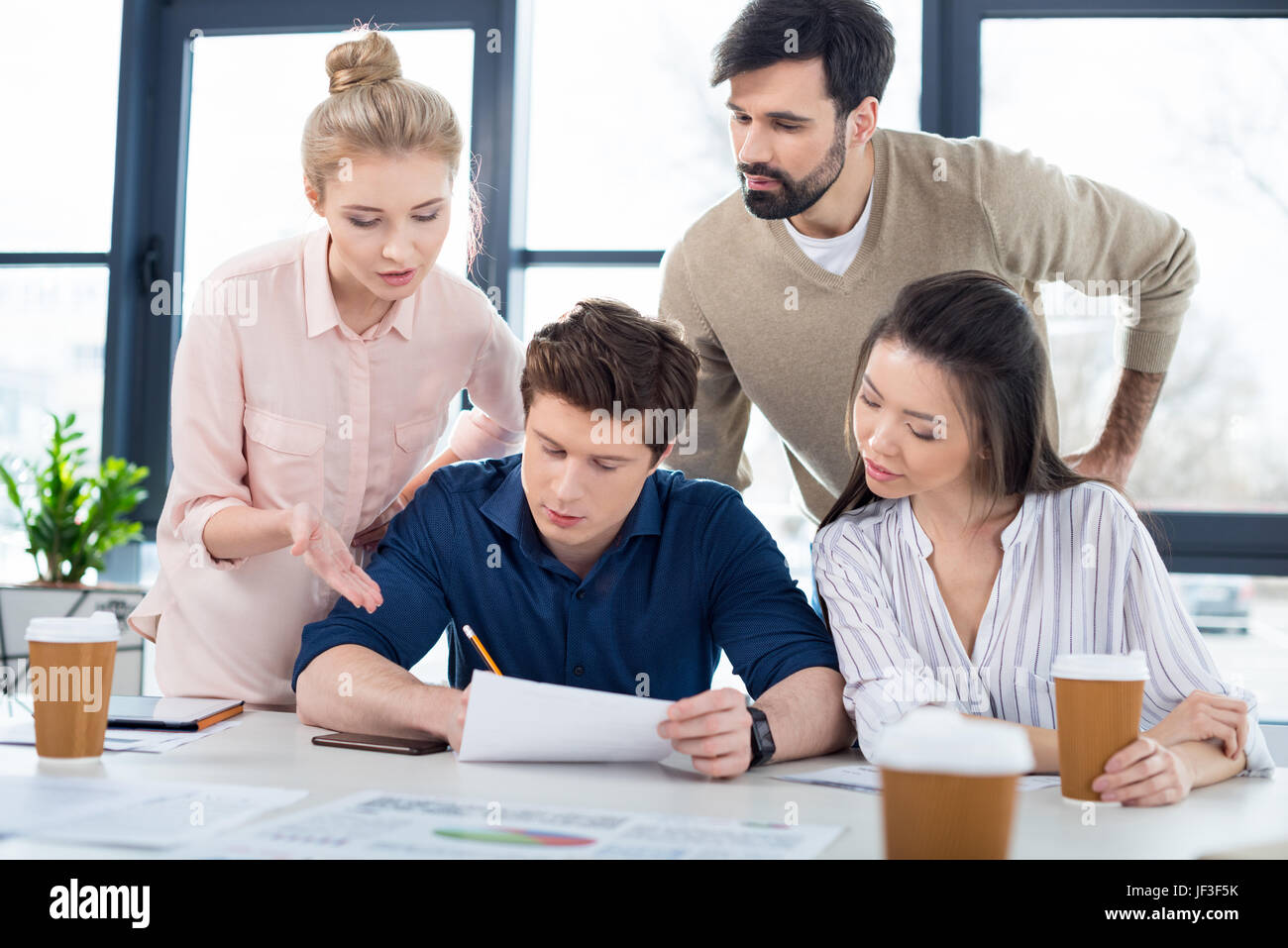 group of young business people discussing new project on meeting Stock ...