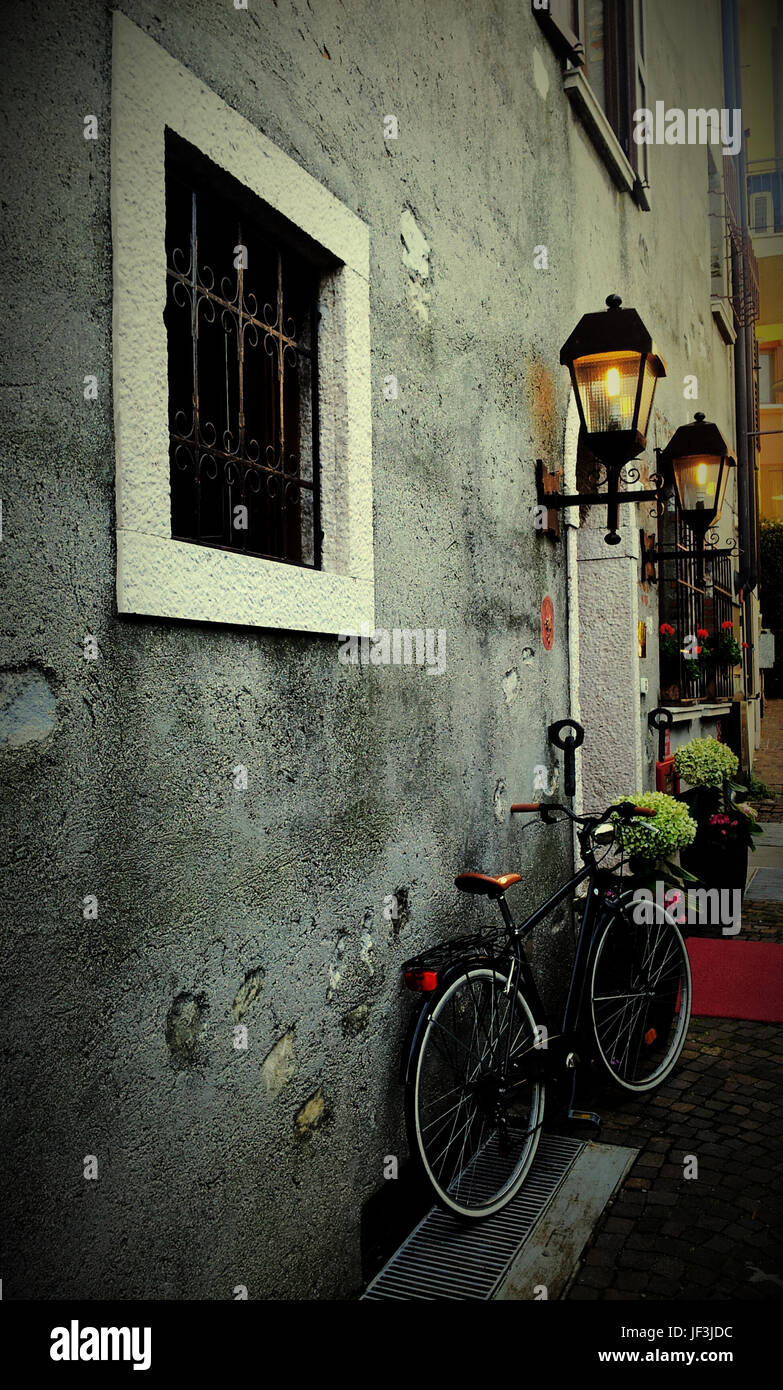 Bicycle Under Window Stock Photo - Alamy