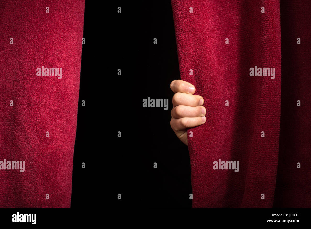 Hand appearing beneath the curtain Stock Photo - Alamy