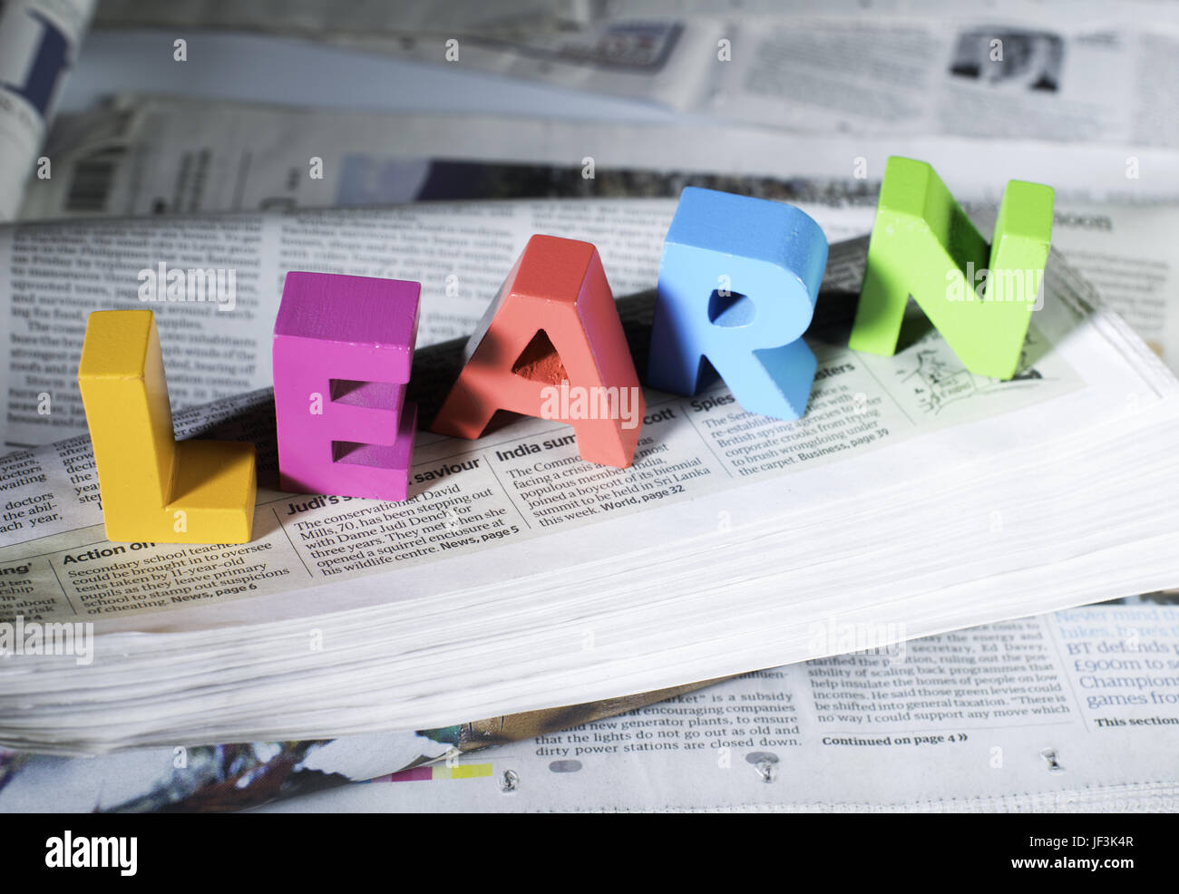 Word learn on newspaper Stock Photo - Alamy