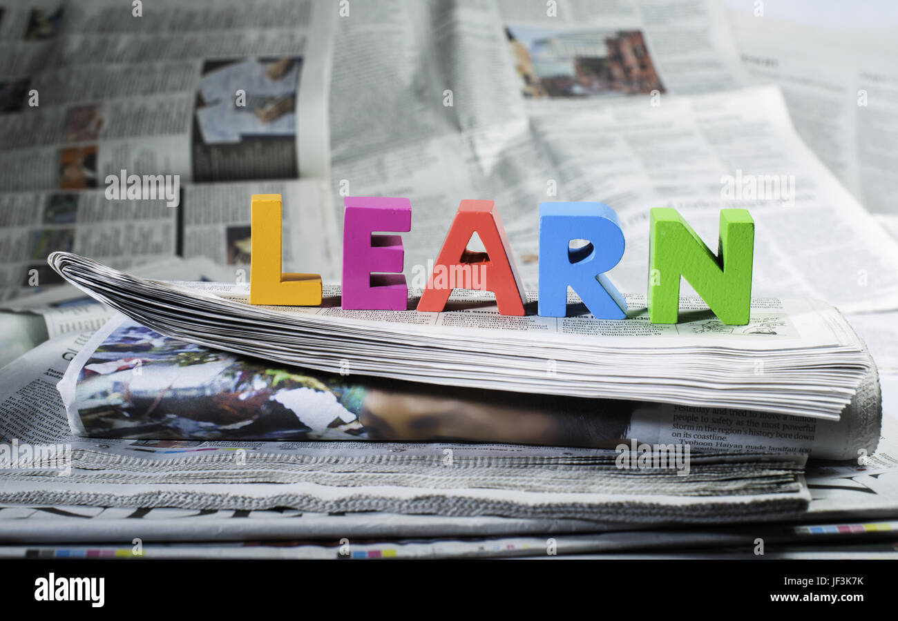 Word learn on newspaper Stock Photo - Alamy