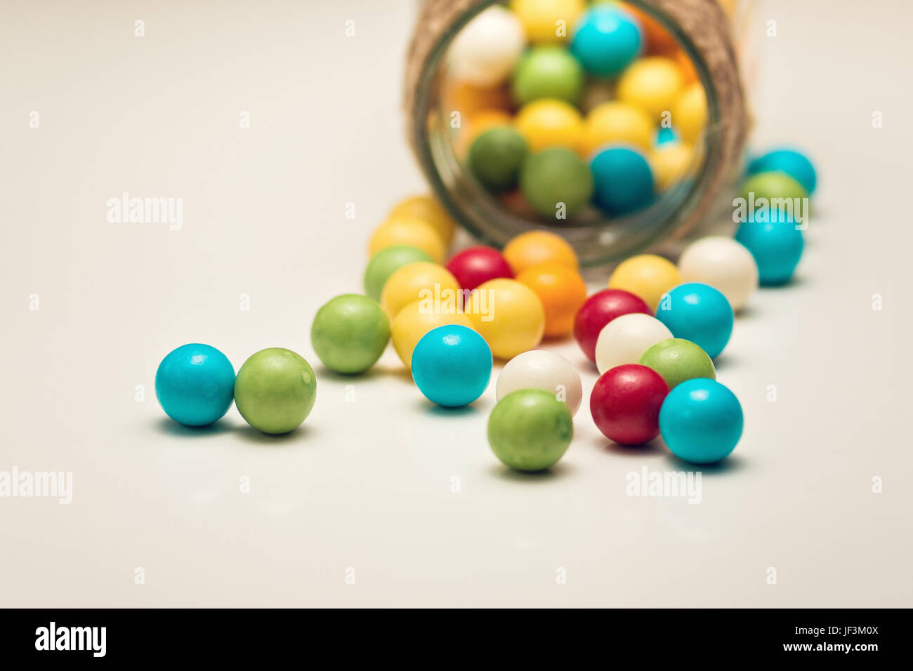 Colored chewing gum balls in container Stock Photo - Alamy