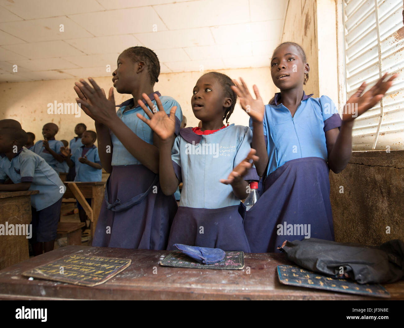 Primary school students sing a song for an Army civil affairs team as ...
