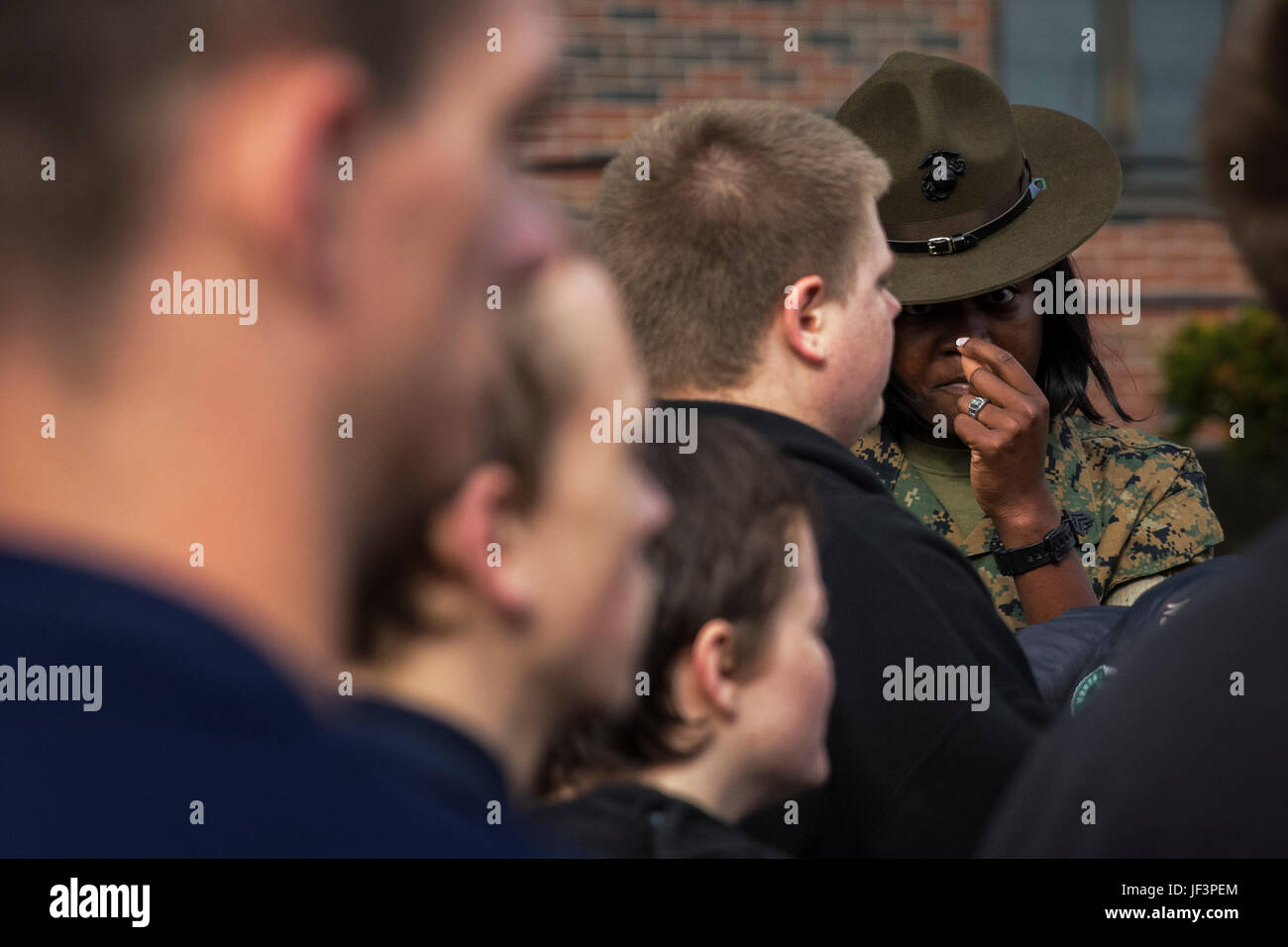 U.S. Marine Corps Sgt. Courtney Holliday corrects a Marine enlistee on ...