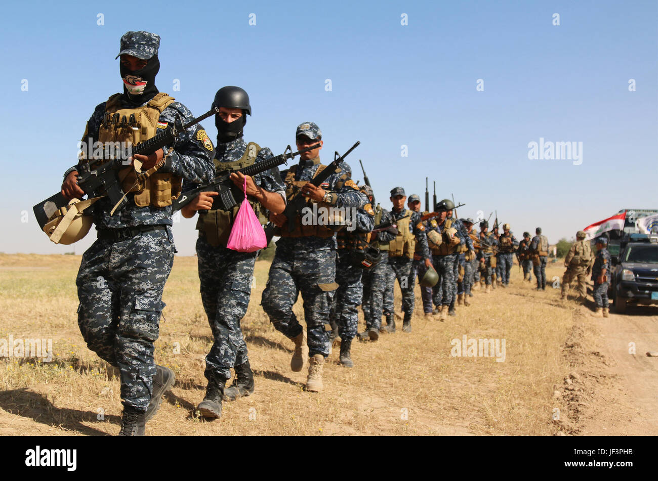 Iraqi Federal Police snipers march onto the rifle range to conduct ...