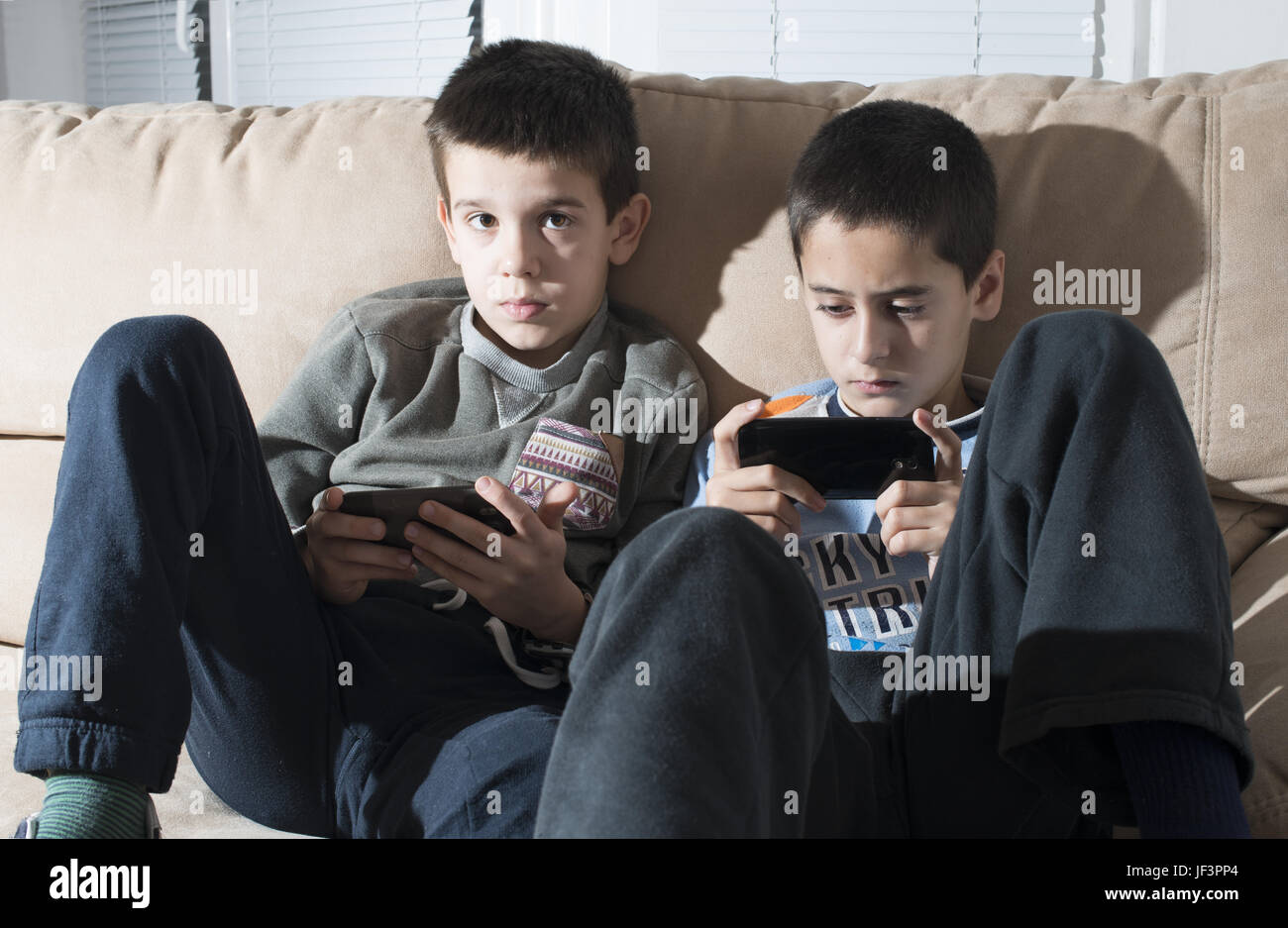 Children playing with their smartphones Stock Photo - Alamy