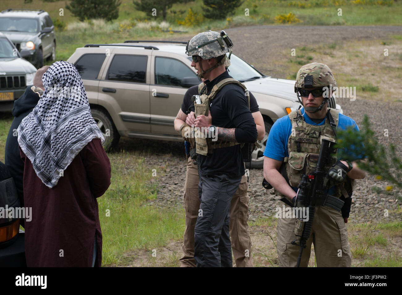 Oregon Army National Guard Sgt. Adam Tschida (right), with the 1186th Military Police Company ...