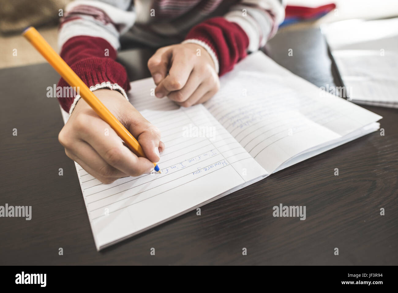 Child write in a notebook Stock Photo - Alamy