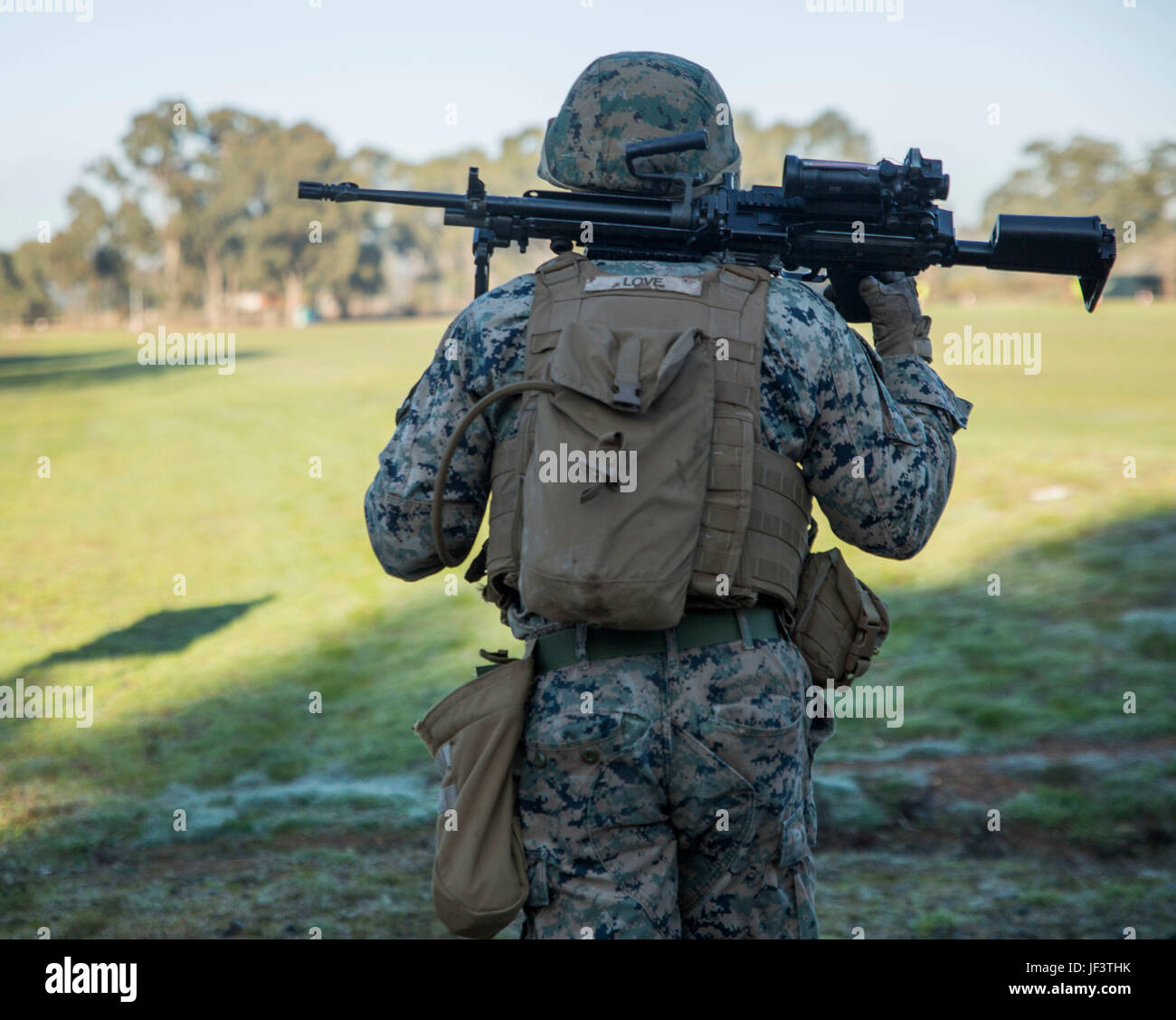 U.S. Marine Corps Cpl. Zach Love carries in the M249 to finish off the ...