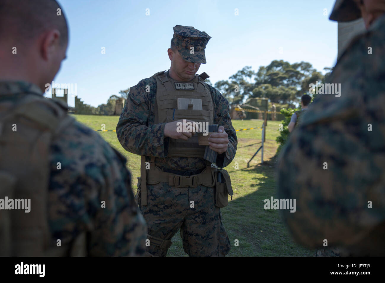 U.S. Marine Corps Capt. Jacob Castillo fills his magazines before the ...