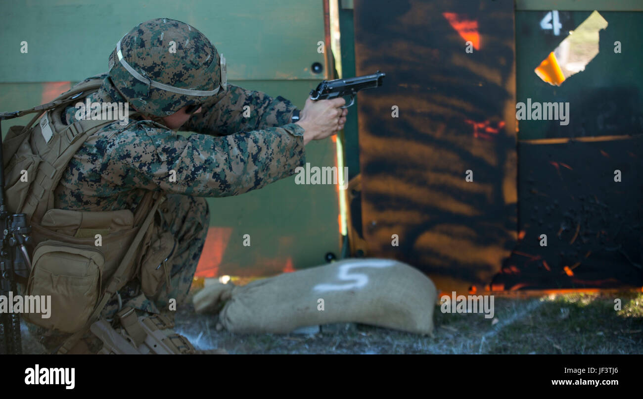 U.S. Marine Corps Lance Cpl. Samuel Sly aims his M9 at his target May ...