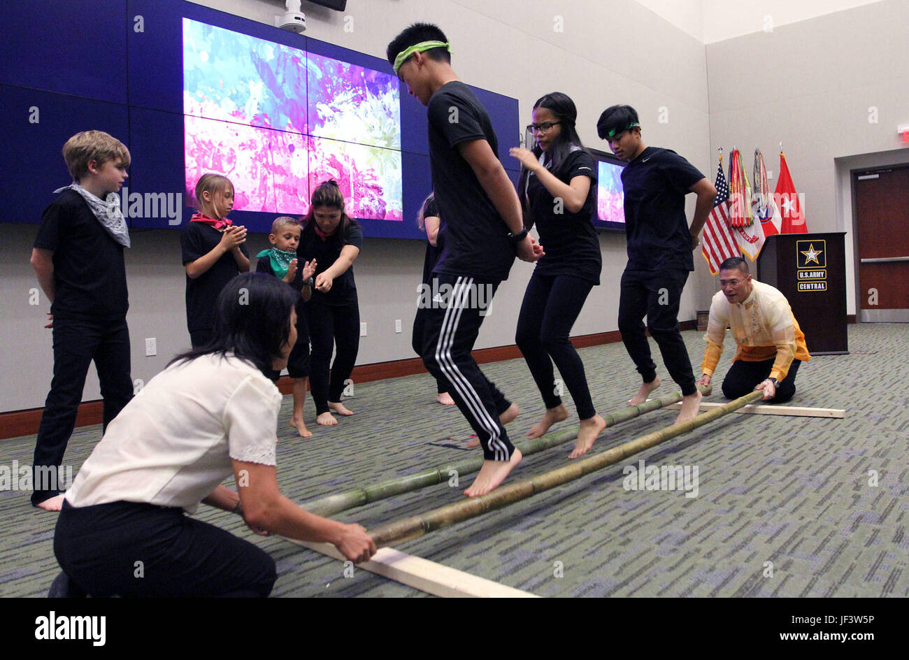 Several U.S. Army Central children perform the Tinikling, as Col. Roy ...