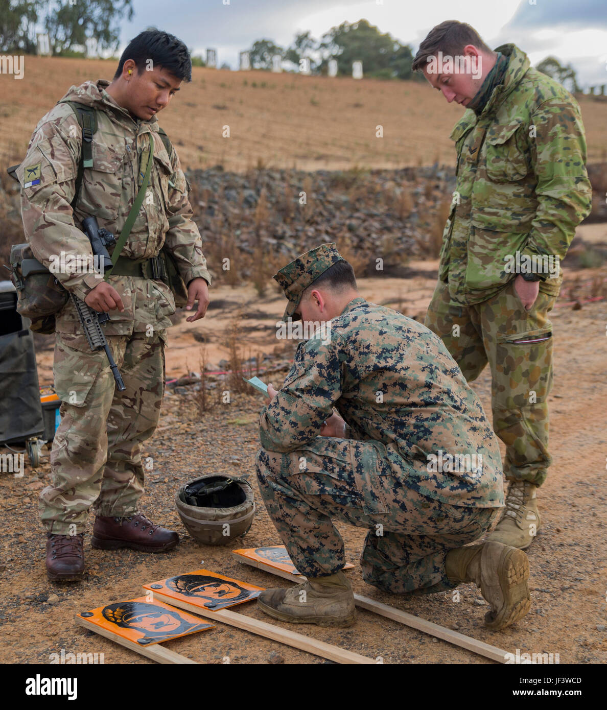 U.S. Marine Corps Sgt. Sean Boyd fills out a United Kingdom soldier’s ...