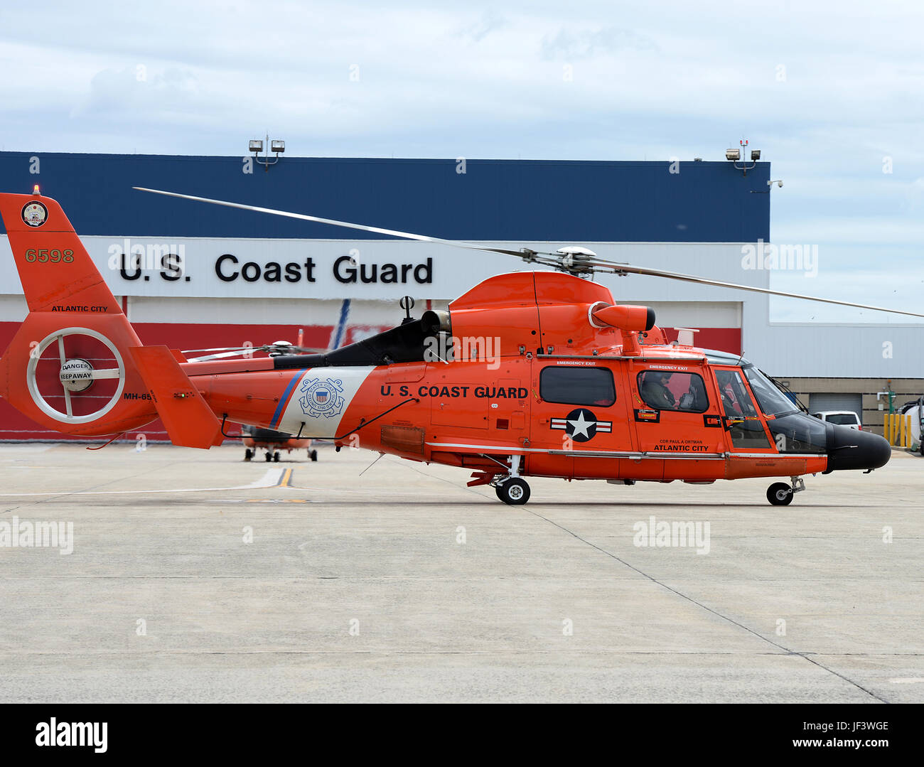 A U.S. Coast Guard HH-65C Dolphin Helicopter prepares to take off for ...