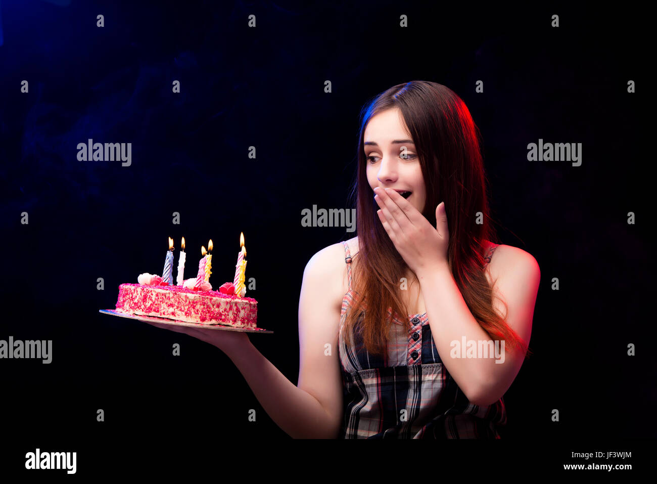 Young woman with birthday cake at party Stock Photo - Alamy