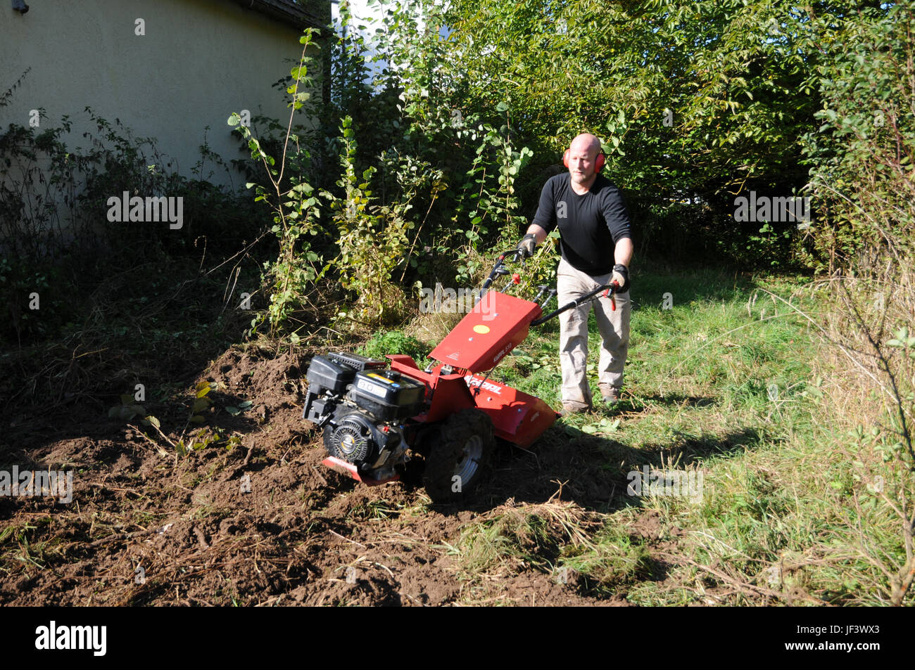 Tilling soil garden hi-res stock photography and images - Alamy