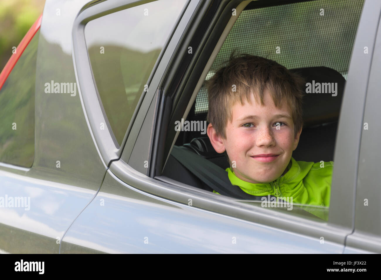 Portrait of boy sitting in car Stock Photo - Alamy