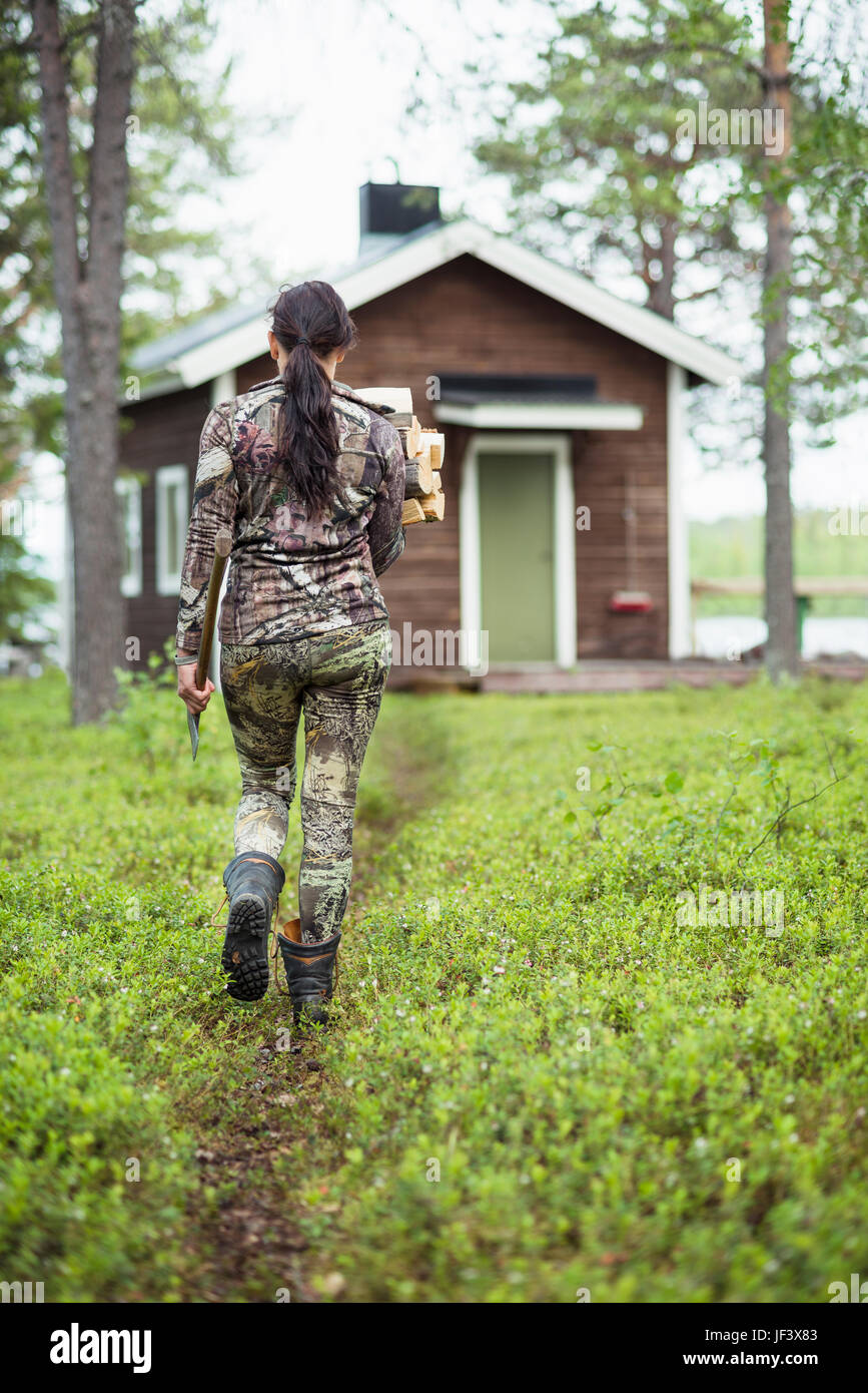 Woman carrying firewood Stock Photo - Alamy