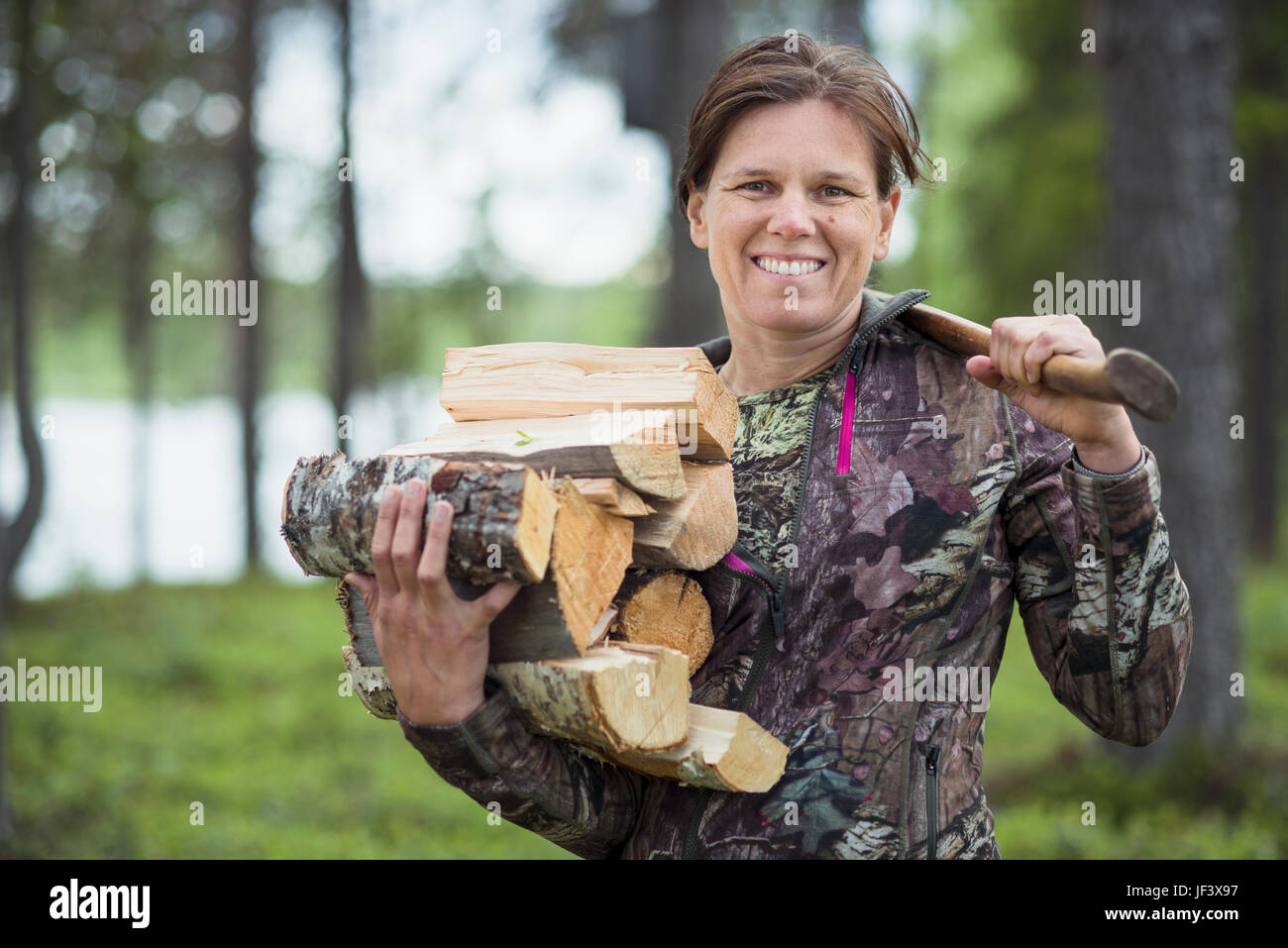 Woman carrying firewood Stock Photo - Alamy