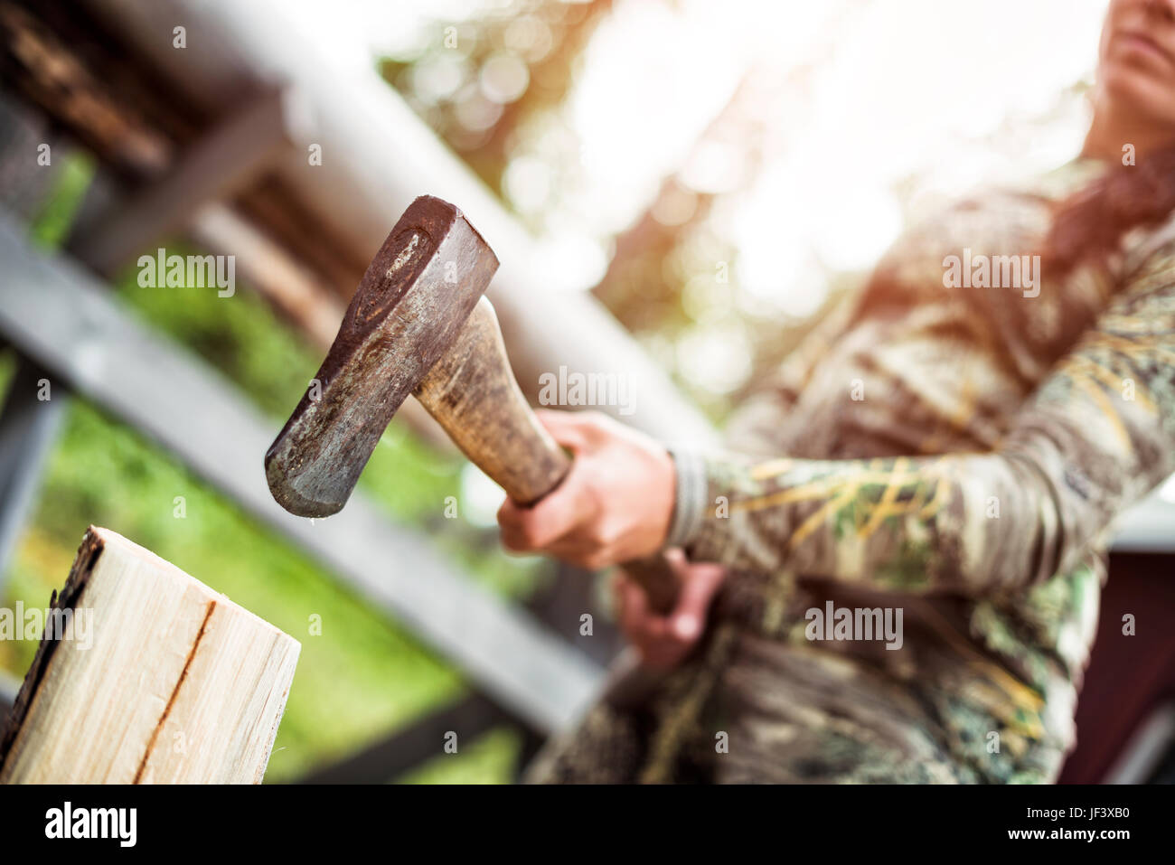 Woman chopping wood Stock Photo - Alamy