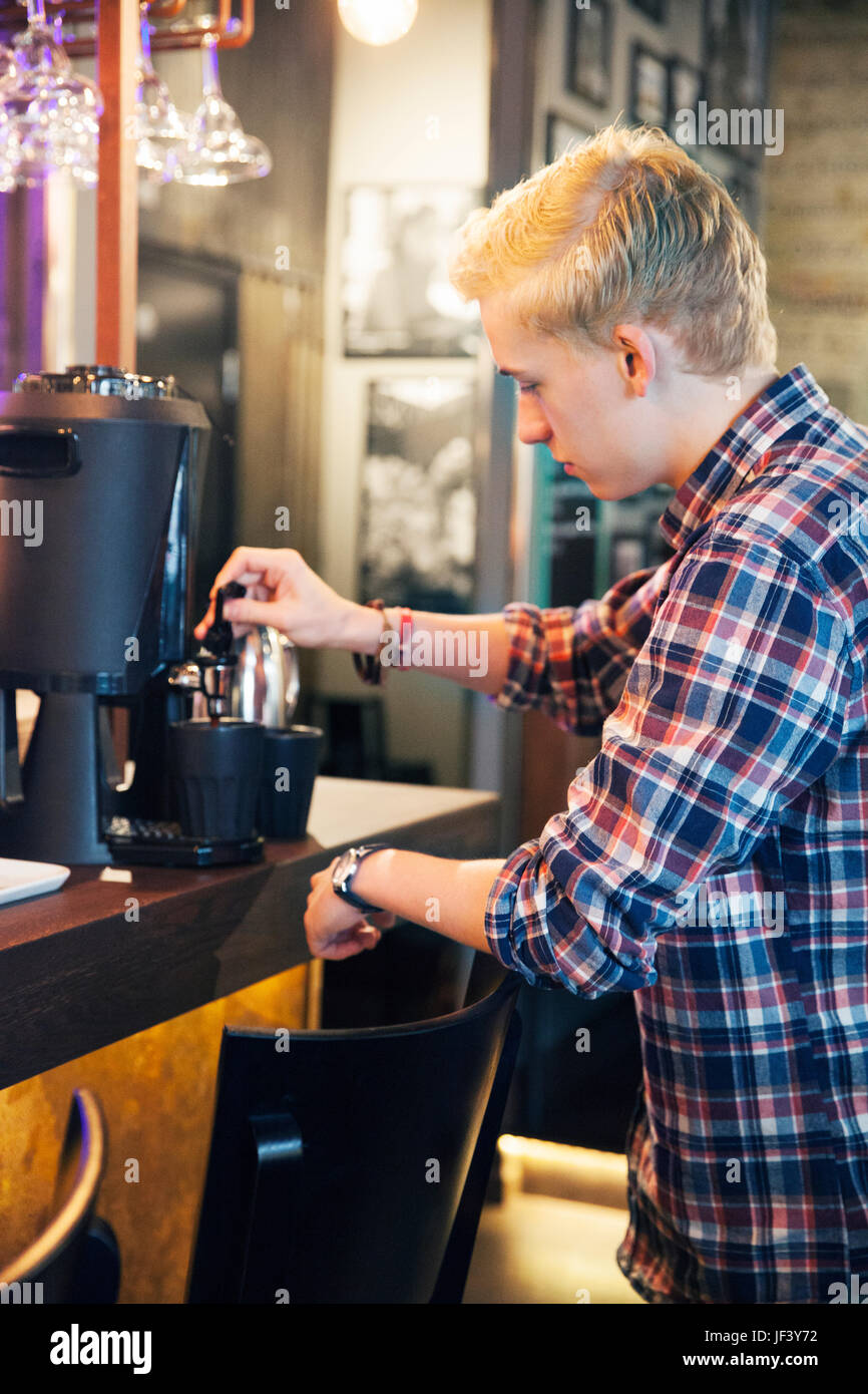 Young man having coffee in cafe Stock Photo - Alamy