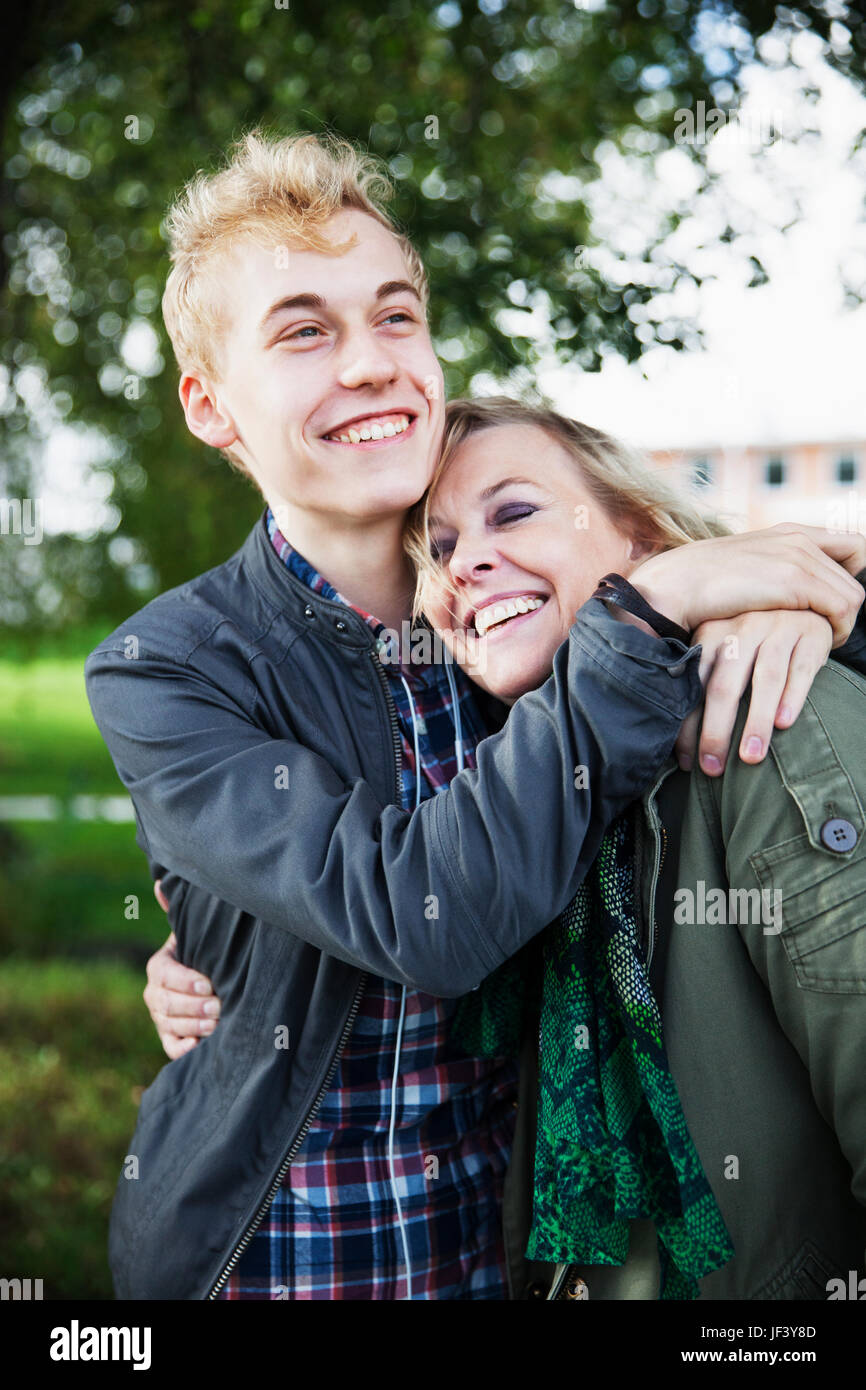 Young man with mother Stock Photo - Alamy