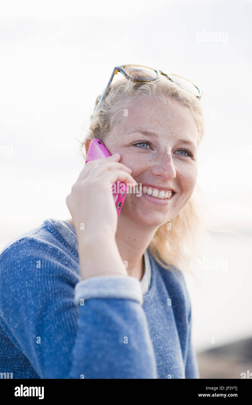 Smiling woman talking through phone Stock Photo - Alamy