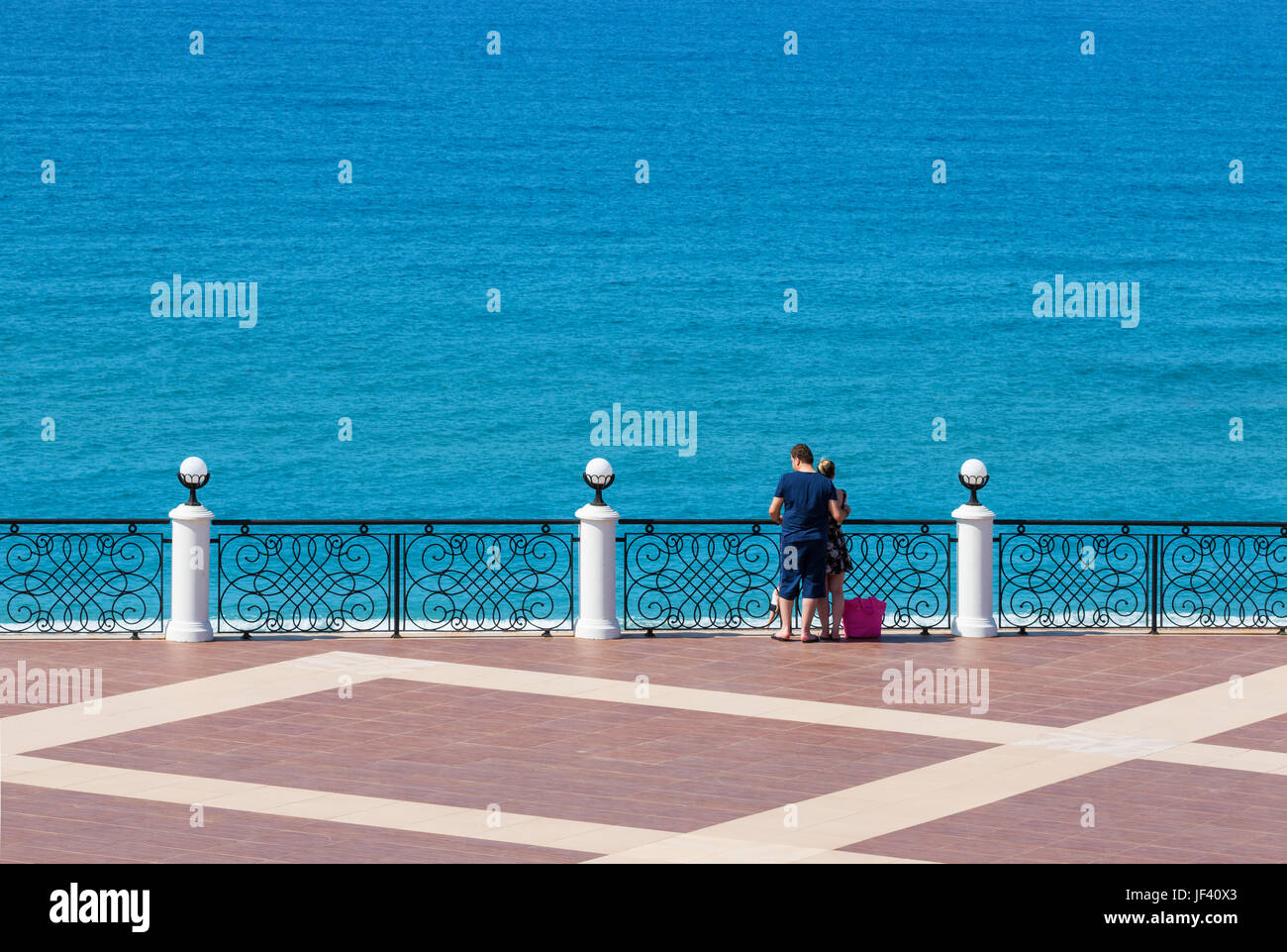 Love couple standing on a terrace in a Turkish resort, above ...