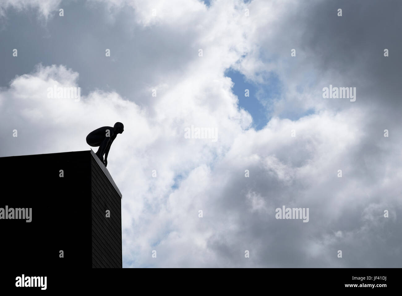 Silhouette of man standing on rooftop Stock Photo - Alamy