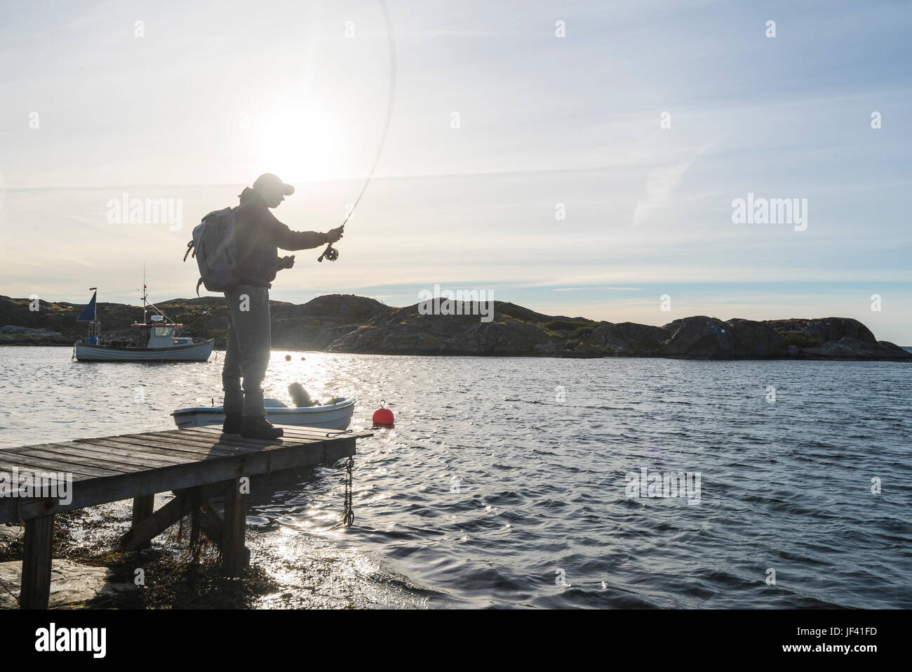 Man fishing at sea Stock Photo - Alamy