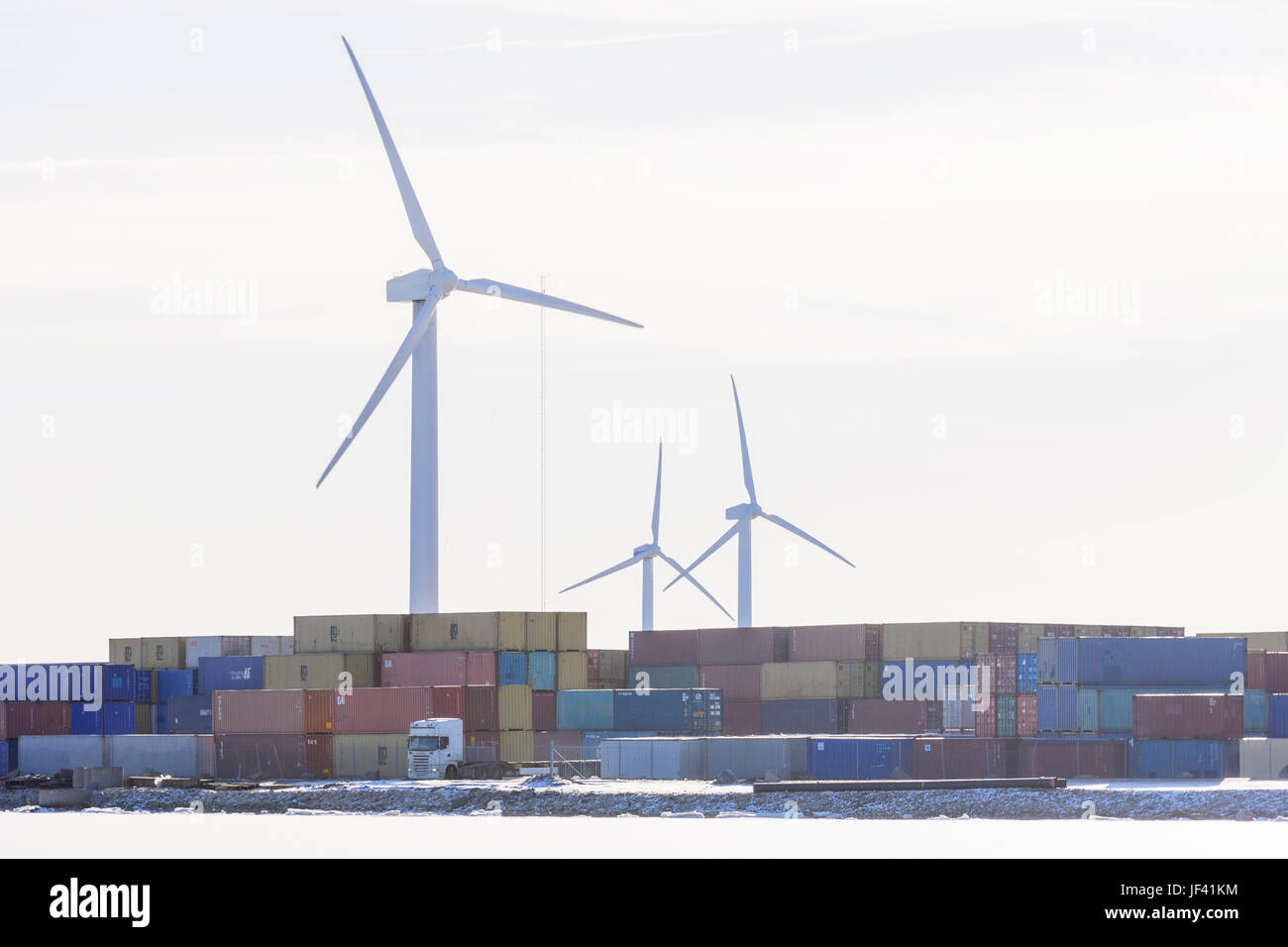 Wind turbines, cargo containers on foreground Stock Photo - Alamy