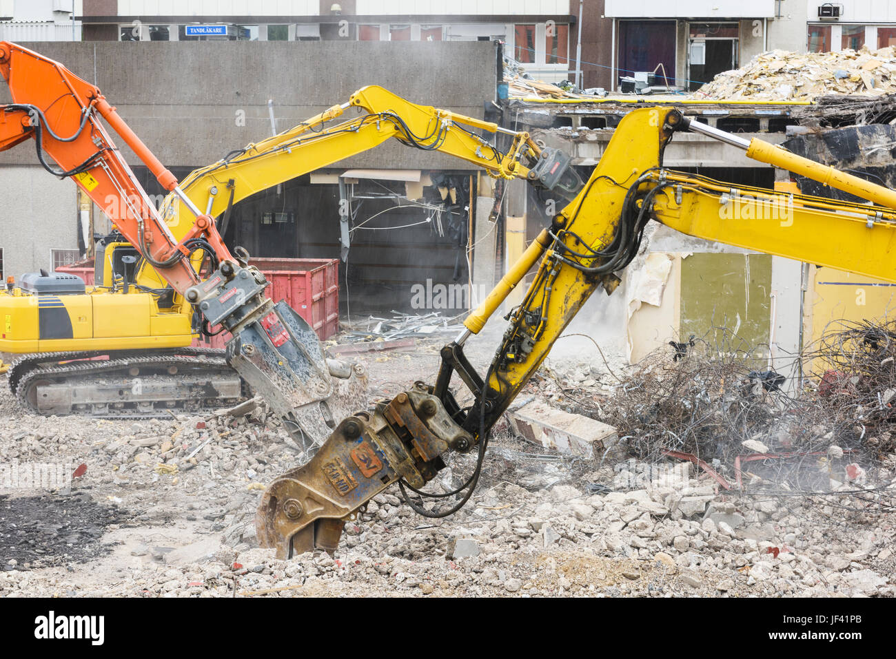 Diggers demolishing buildings Stock Photo - Alamy