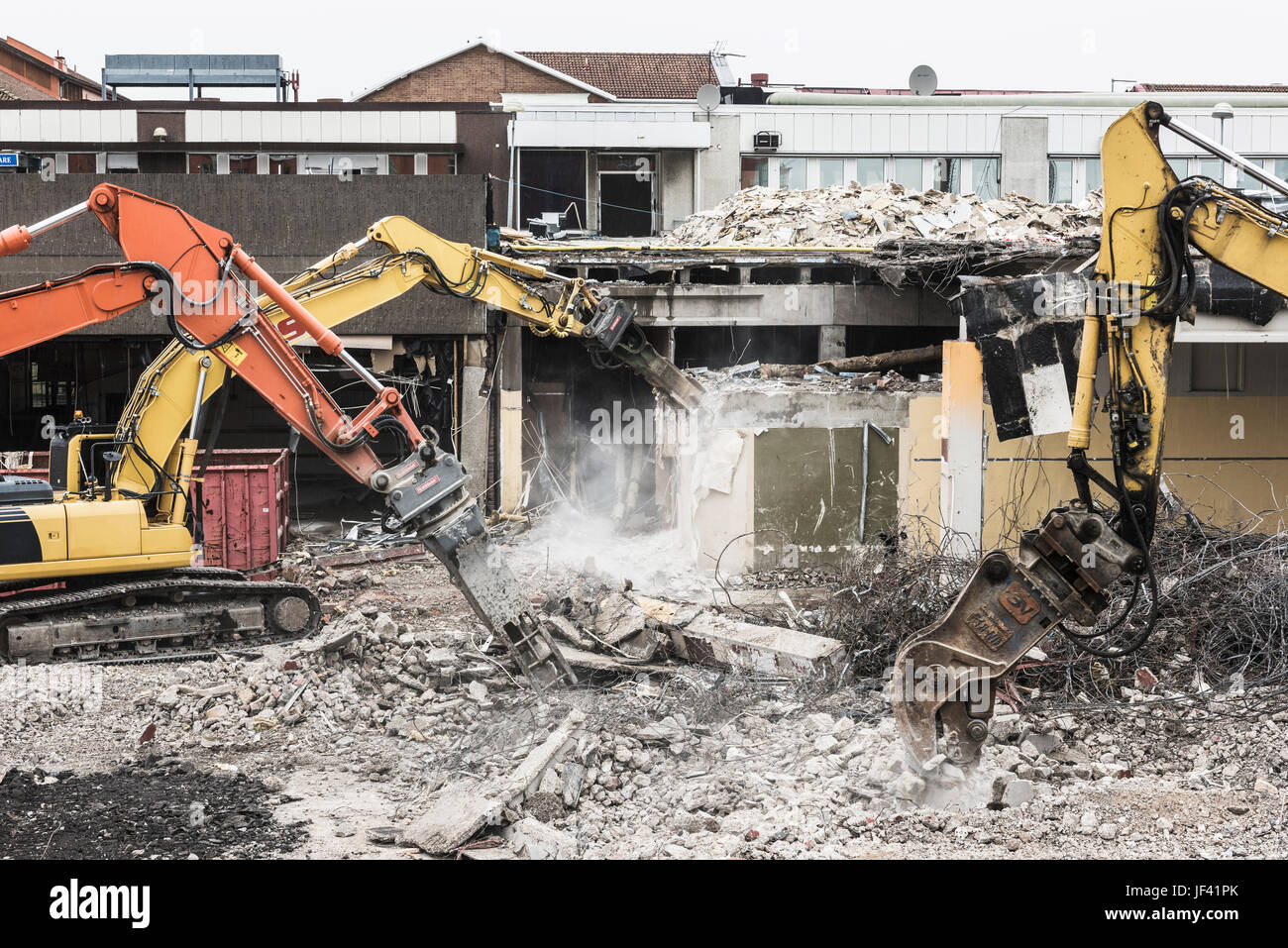 Diggers demolishing buildings Stock Photo - Alamy