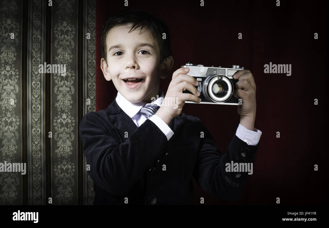 Child taking pictures with vintage camera Stock Photo - Alamy