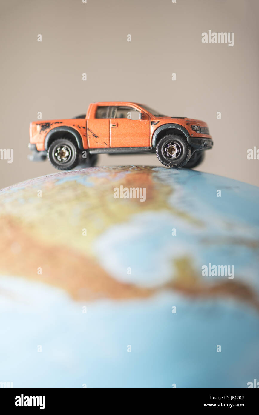 Offroad car on globe Stock Photo - Alamy