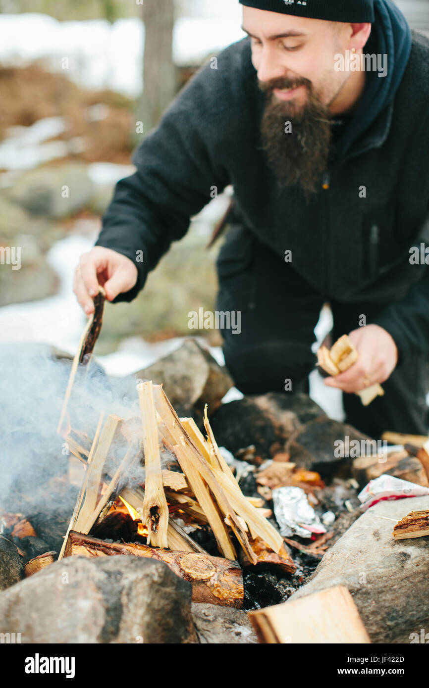 Man making campfire Stock Photo - Alamy