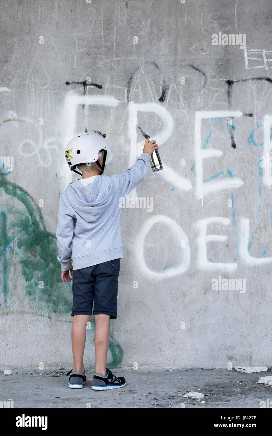 Boy painting on wall Stock Photo - Alamy