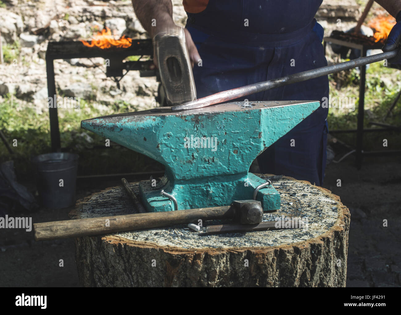 Blacksmith forges iron on anvil Stock Photo - Alamy