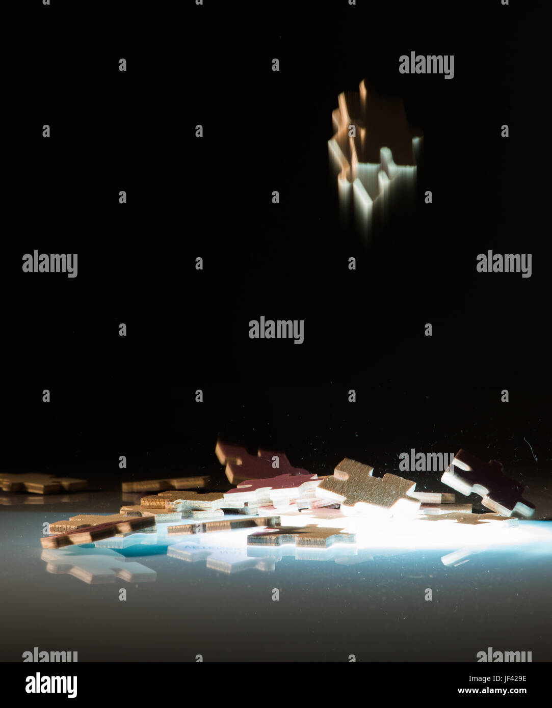 Falling puzzle pieces Stock Photo - Alamy