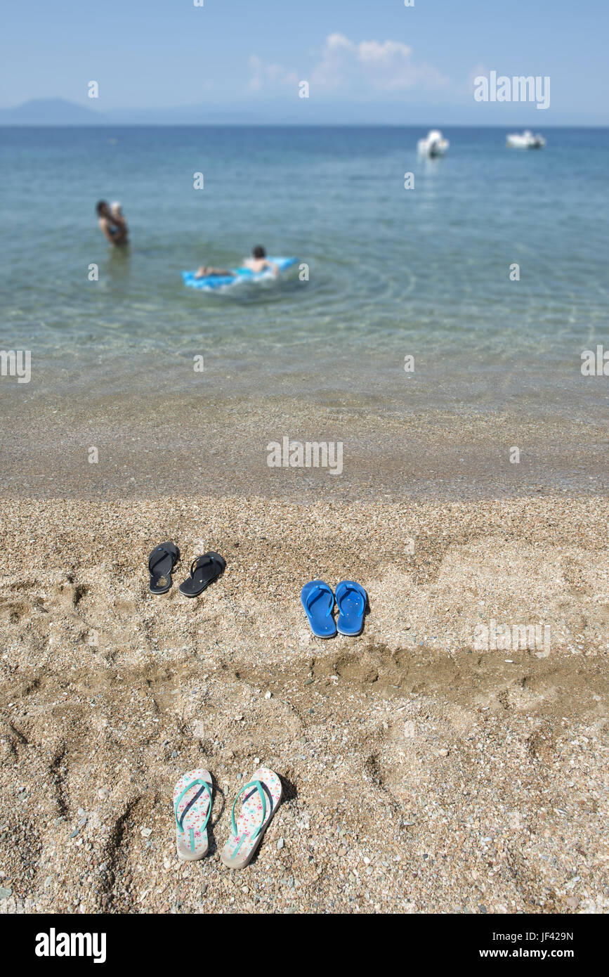 Slippers in the sand on the beach Stock Photo - Alamy