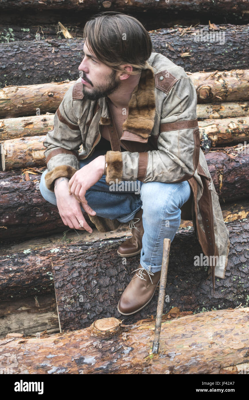 Young men on logs hi-res stock photography and images - Alamy