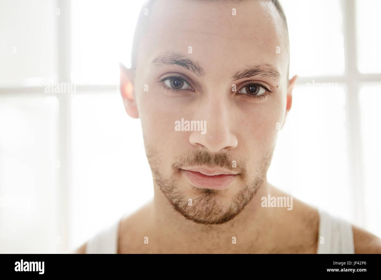 Young man looking at camera Stock Photo - Alamy