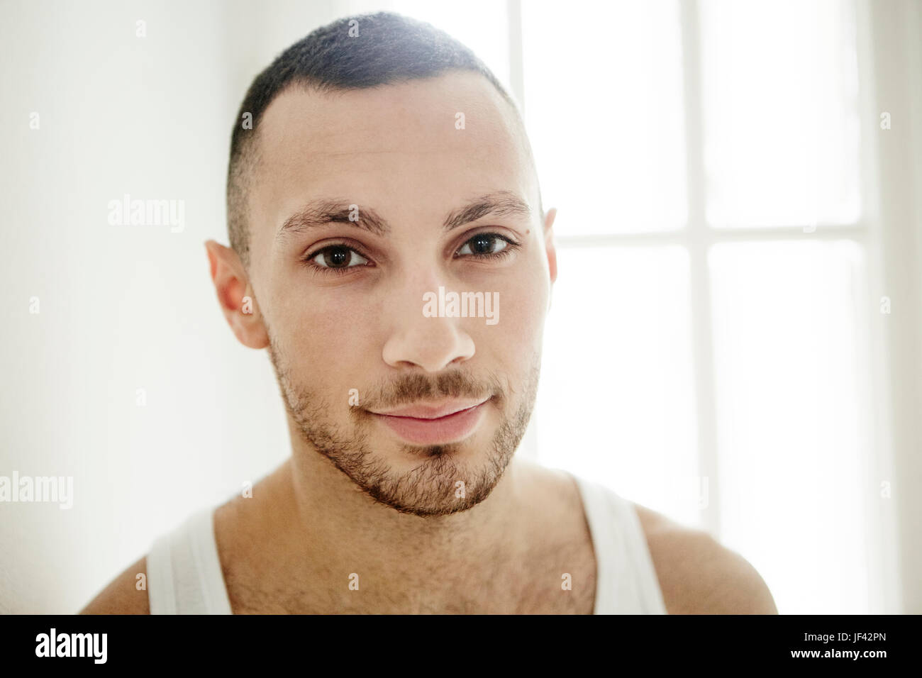 Young man looking at camera Stock Photo - Alamy