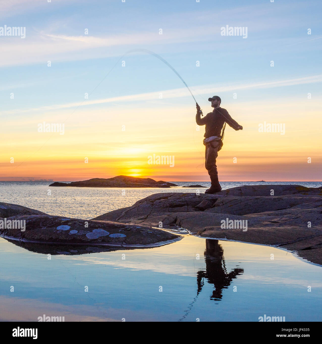 Man fishing at sea Stock Photo - Alamy