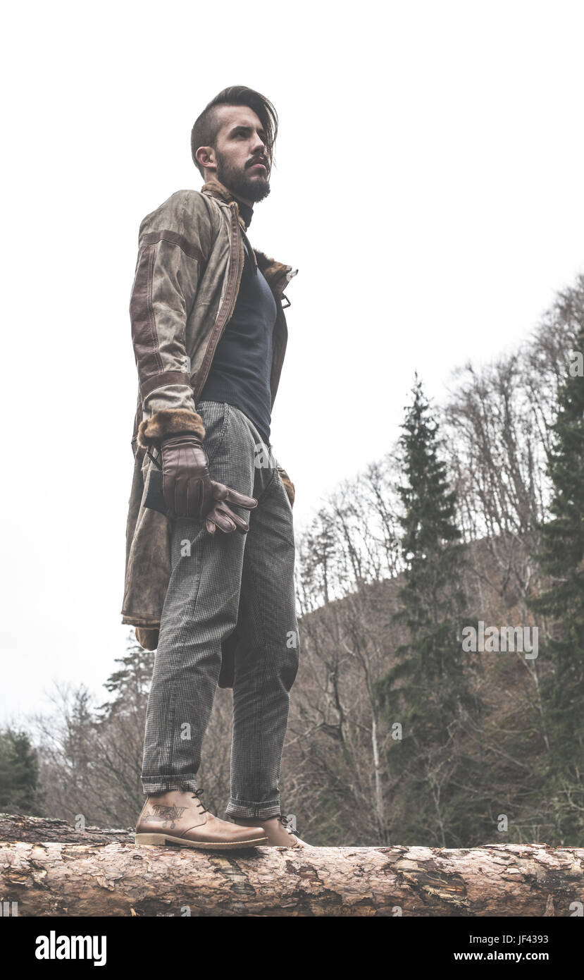 Young men on logs hi-res stock photography and images - Alamy