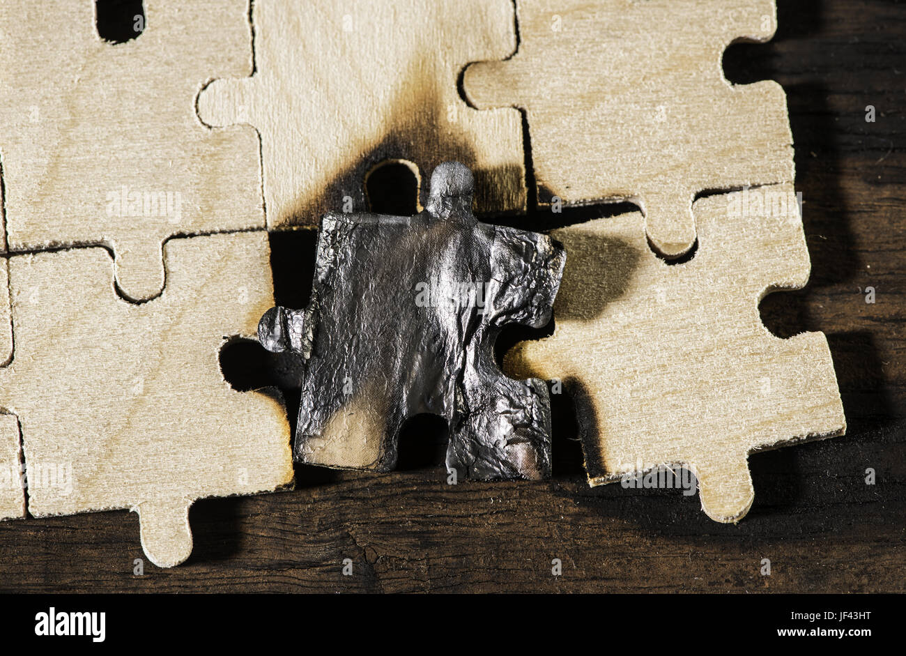 Burning wooden puzzle on dark background Stock Photo - Alamy
