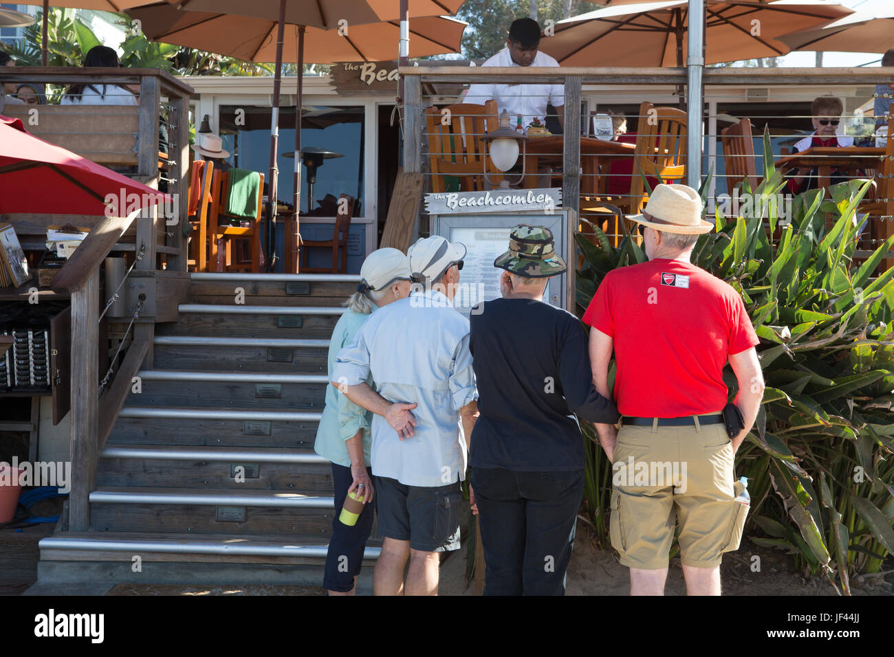 Beach visitors reading the menu outside the Beachcomber Restaurant at ...